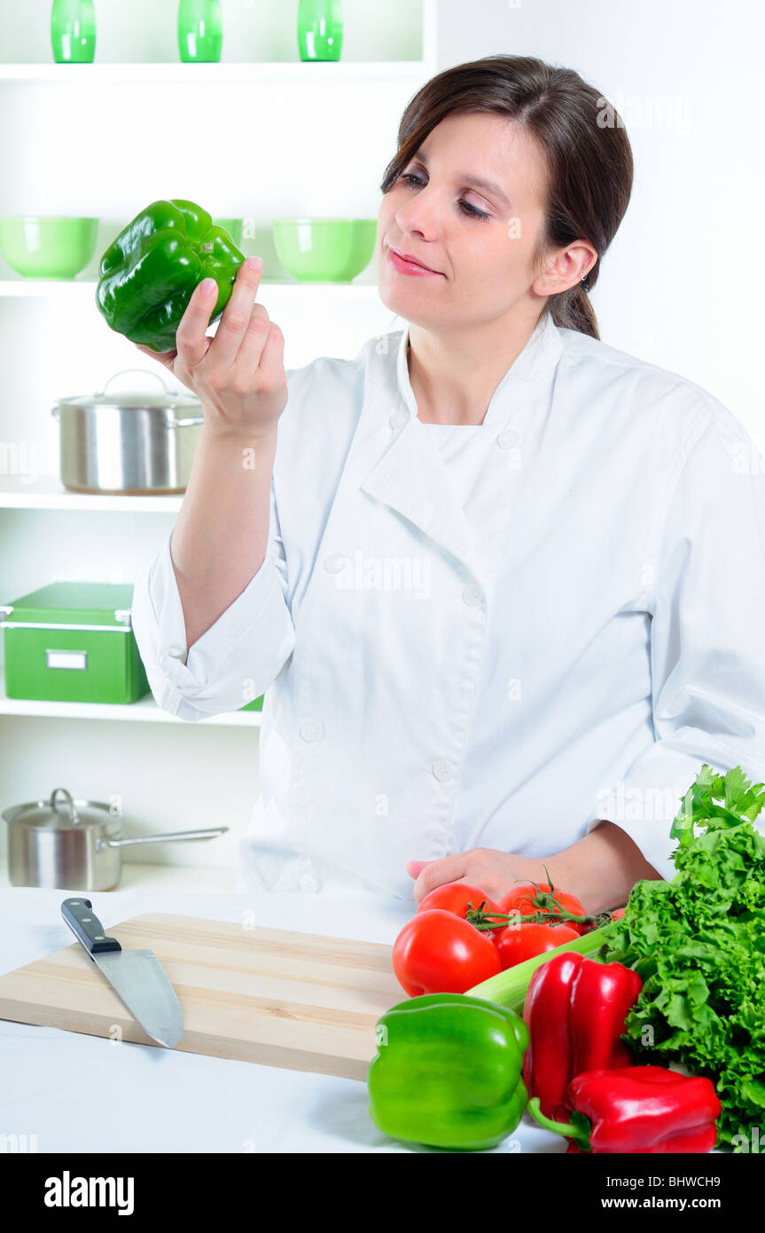 Woman Chef Inspecting A Green Pepper Stock Photo - Alamy