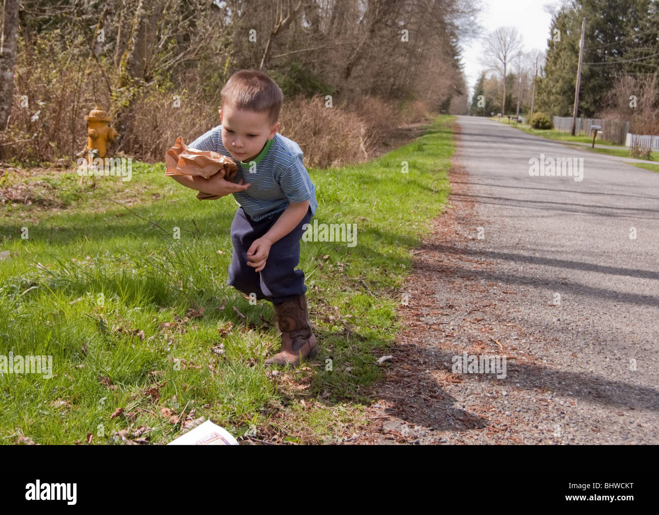 This cute 4 year old Caucasian boy is helping the environment by ...