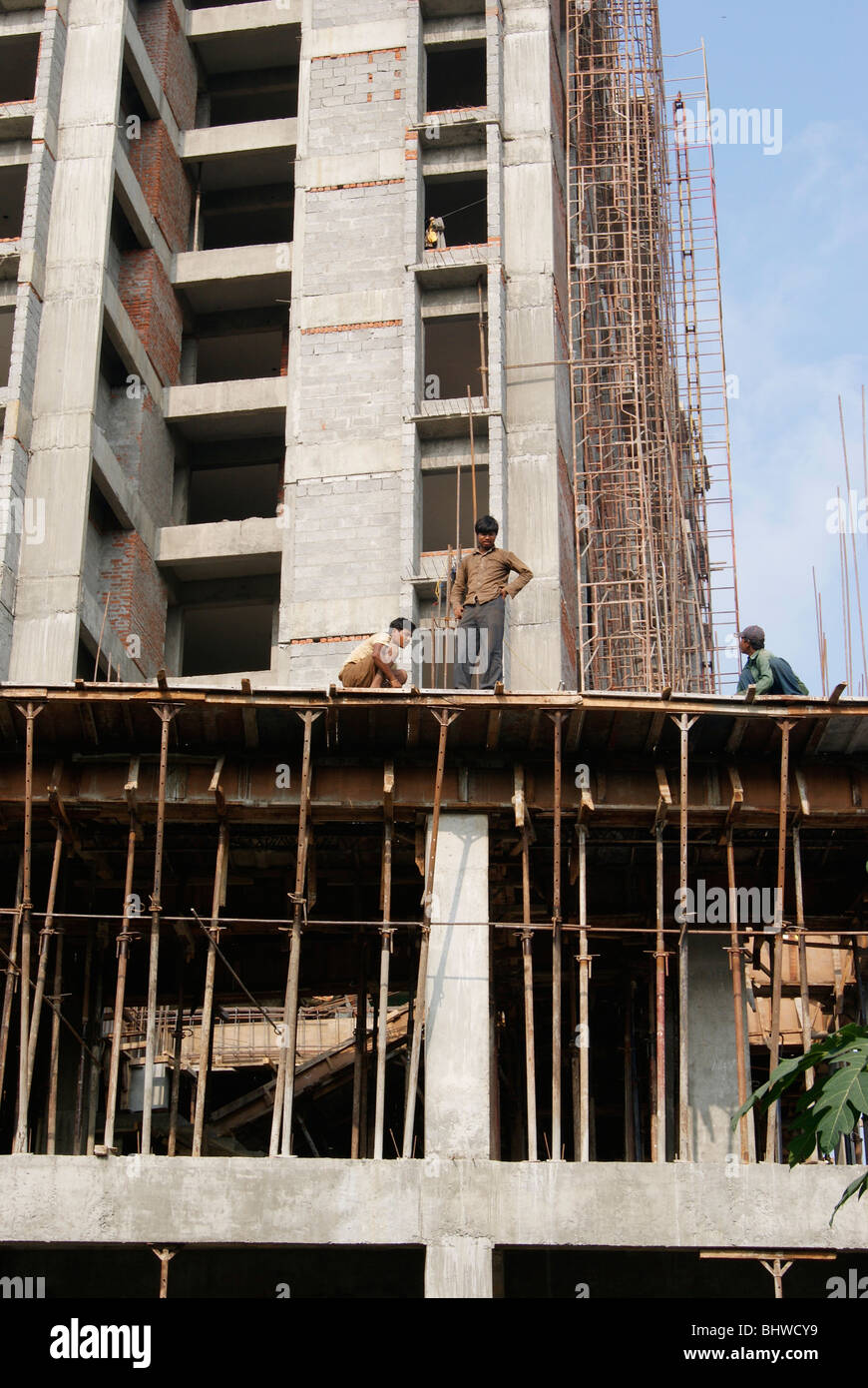 Poor Workers Working Dangerously at the Edge of the structure in a High ...