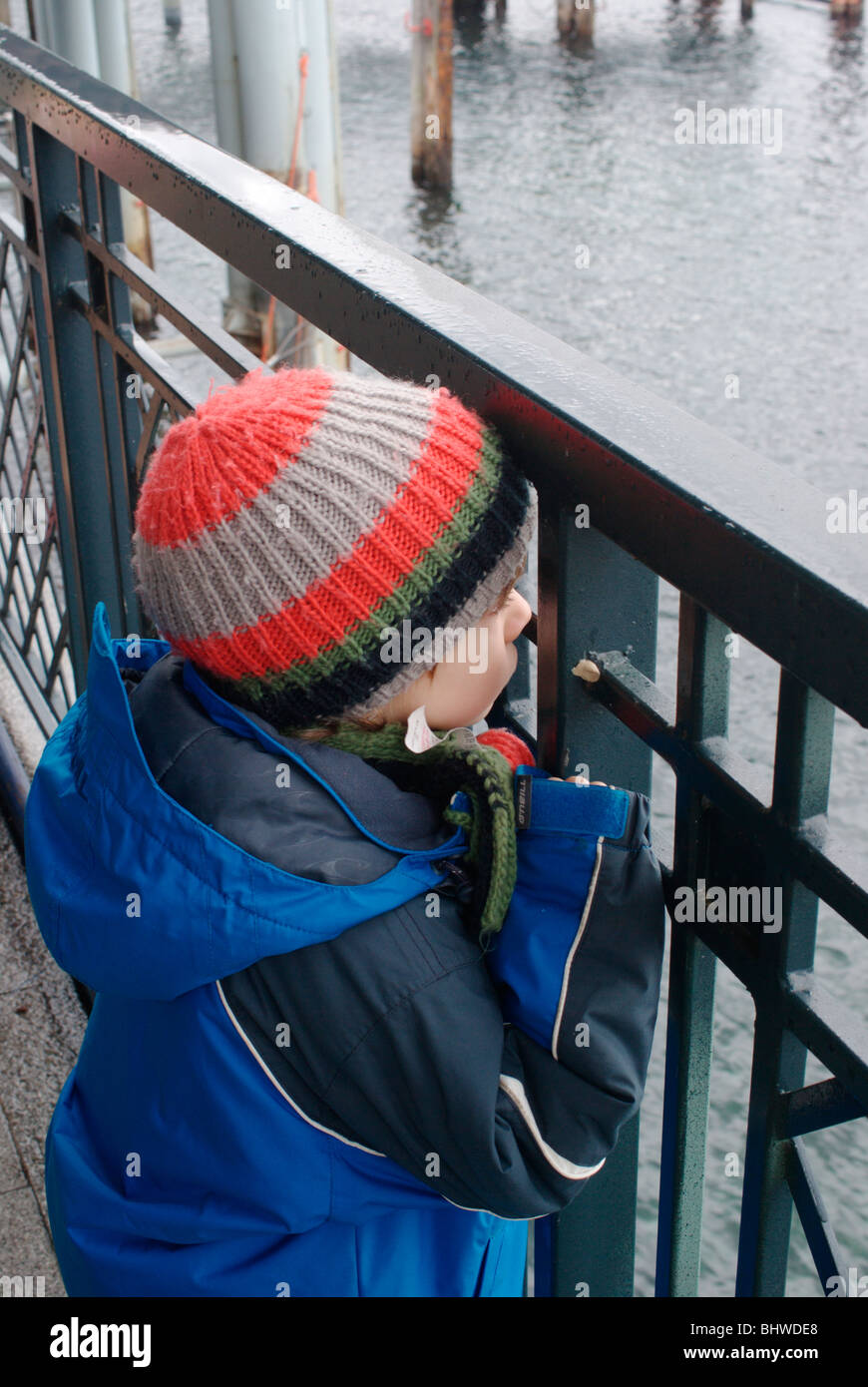 child looks over the railing Stock Photo - Alamy