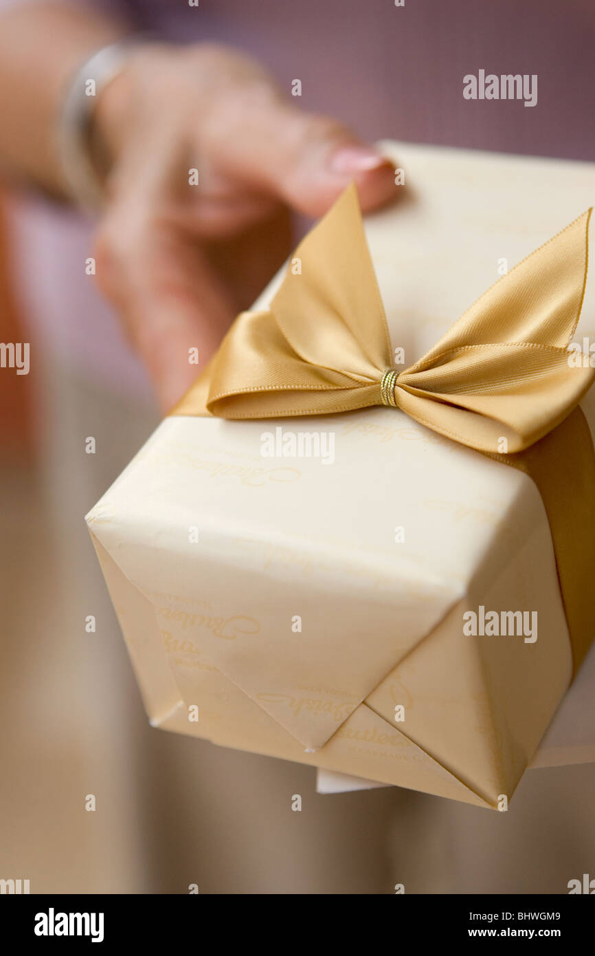 Handing over a present Stock Photo - Alamy