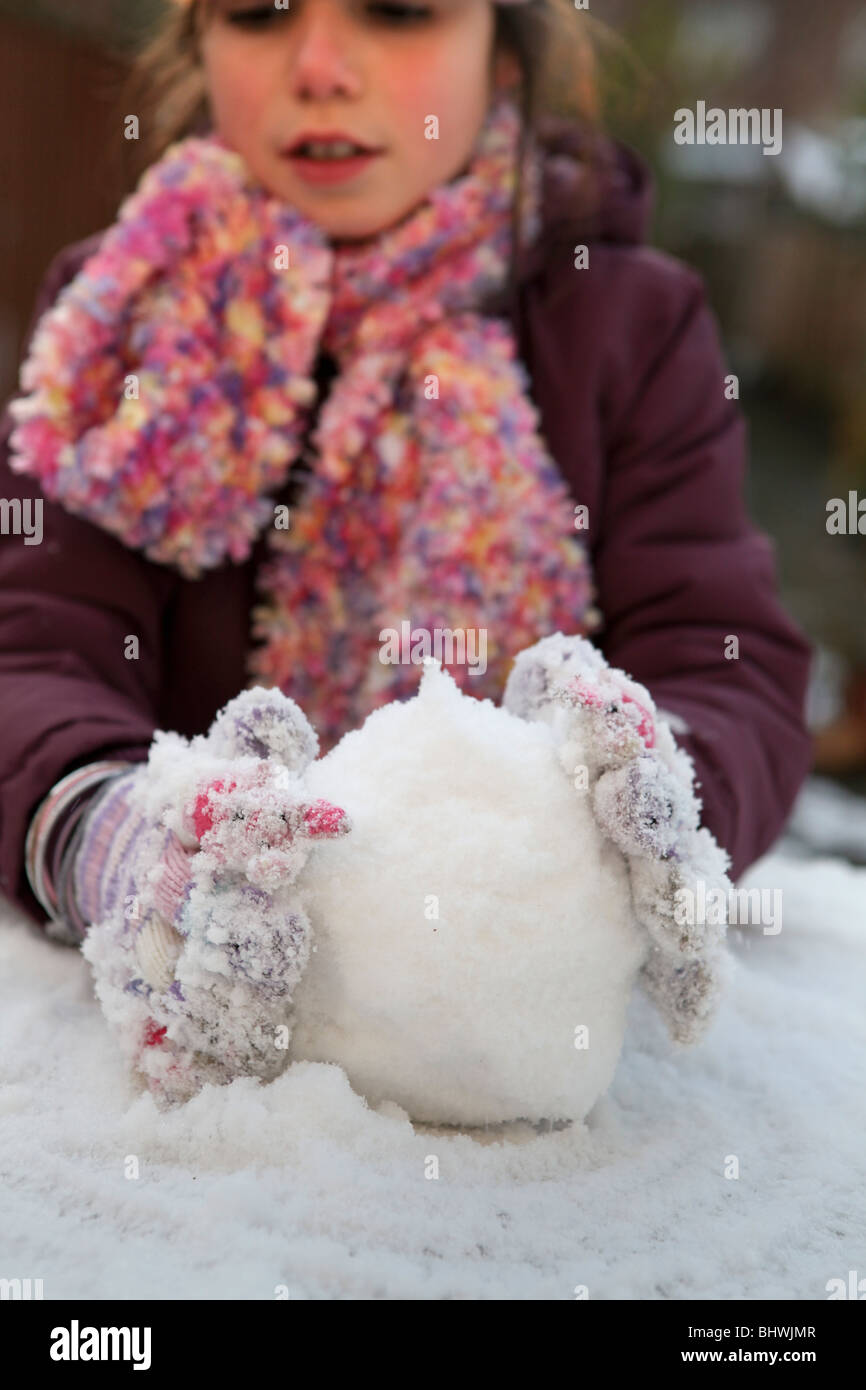 Child playing with snowball Stock Photo - Alamy