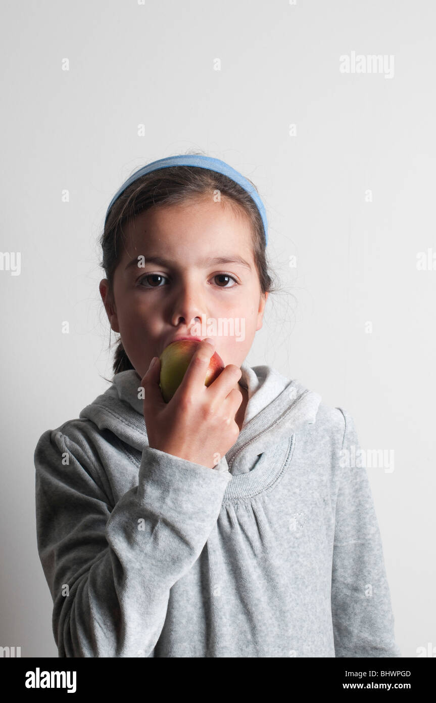 Child biting into an apple Stock Photo - Alamy