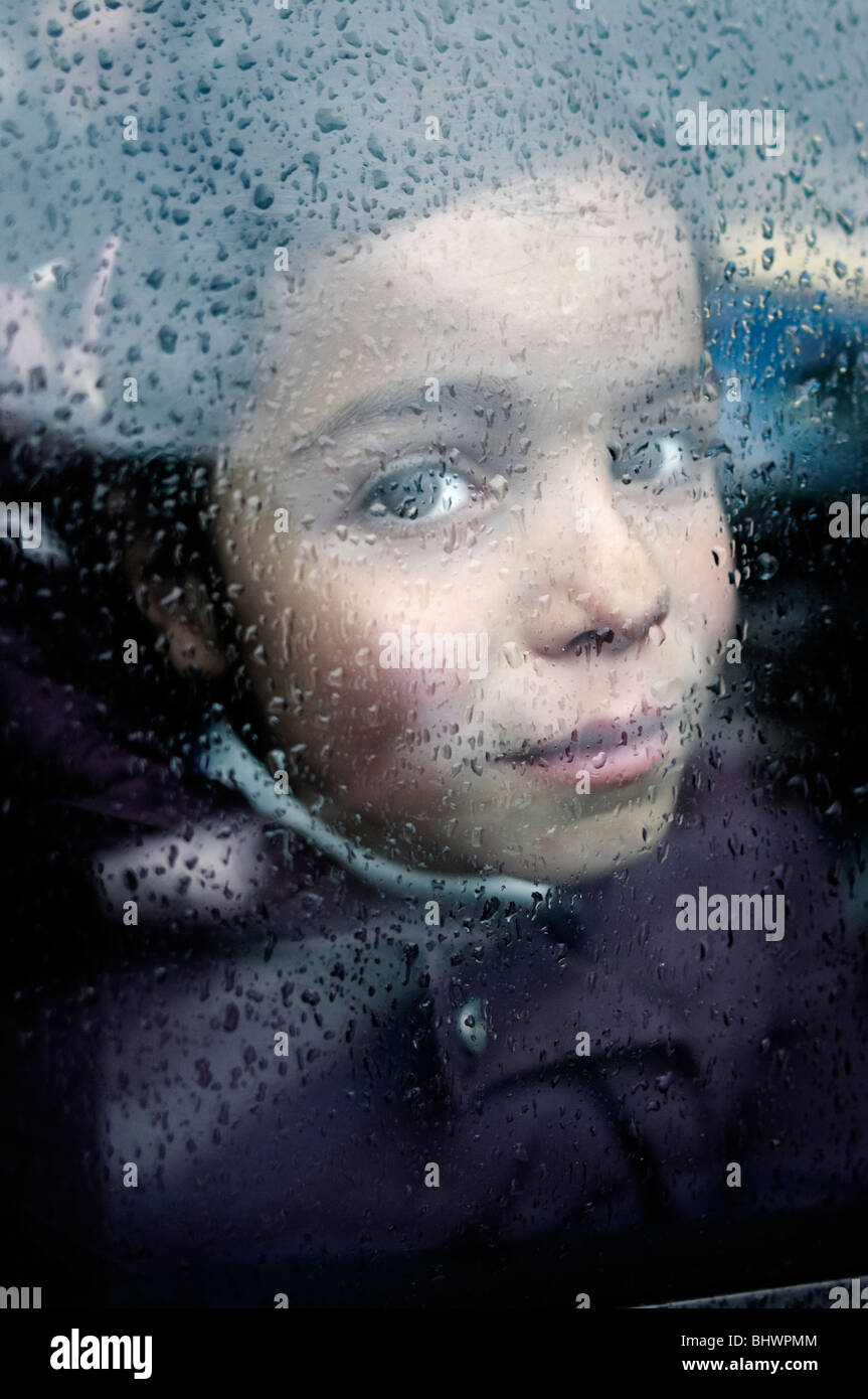 Girl looking out the window Stock Photo - Alamy