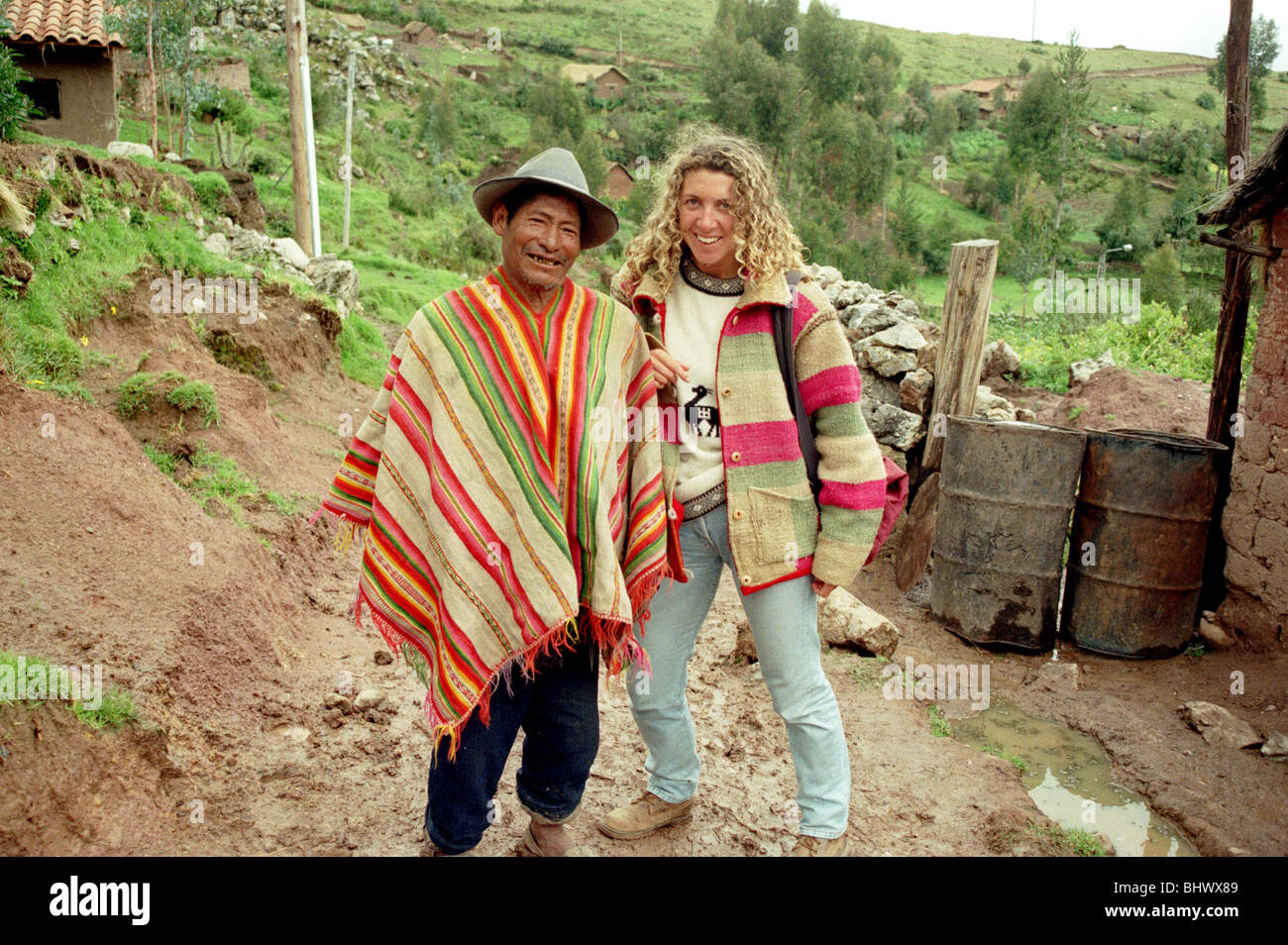 Peruvian famer with European tourist on the outskirts of Cuzco circa ...