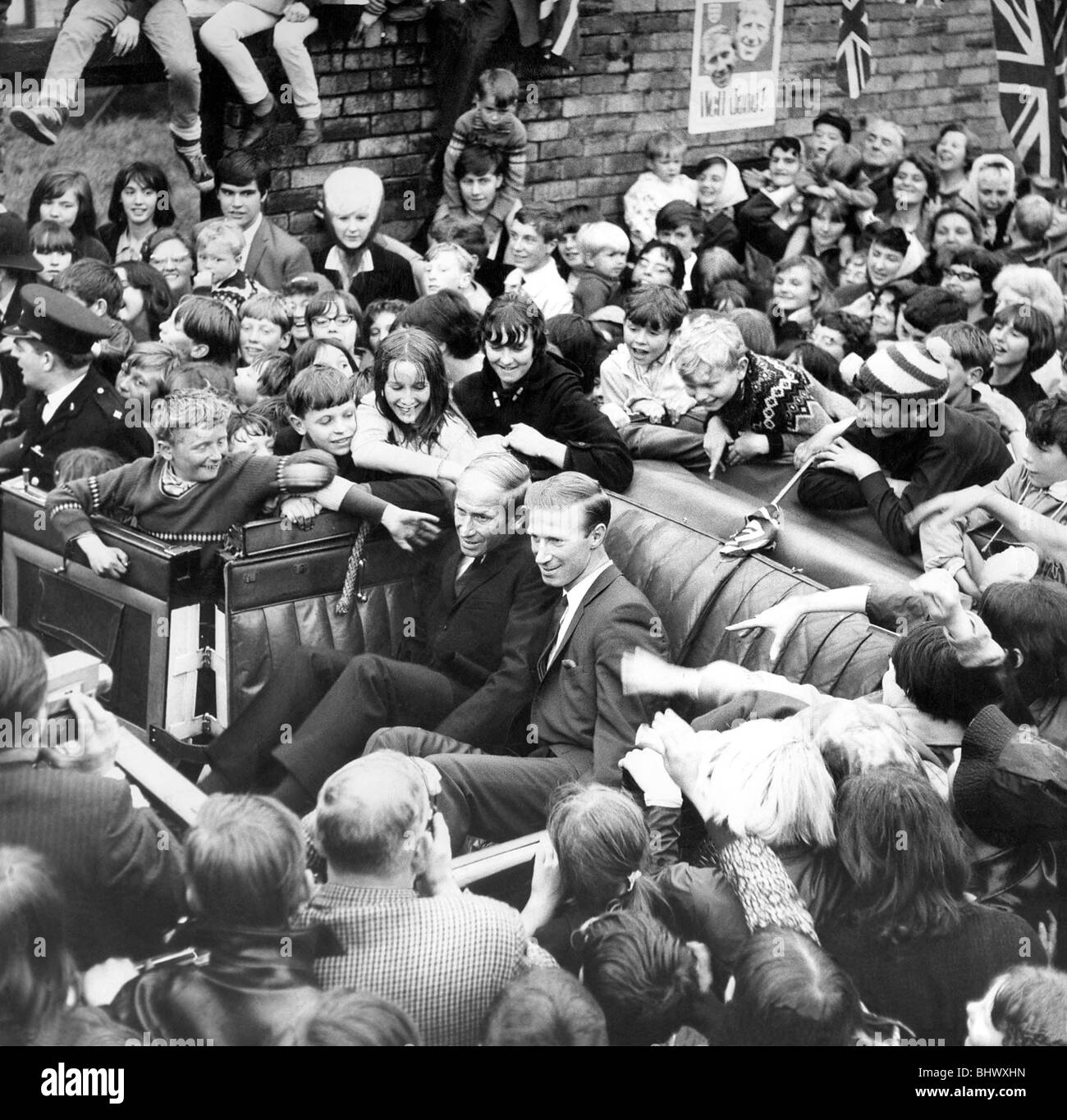 Jack and Bobby Charlton look over-awed as youngsters crowd around the ...