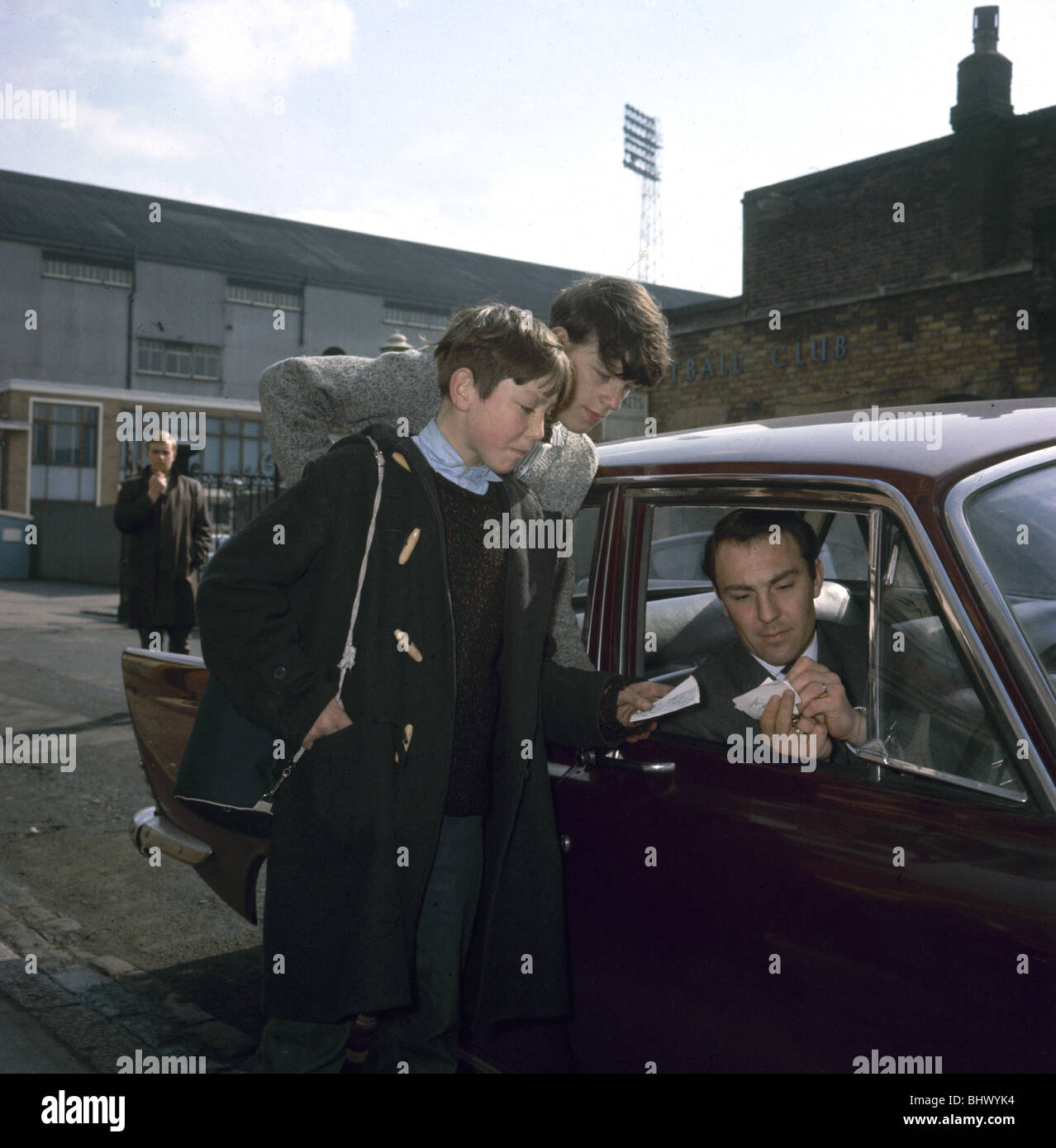 Jimmy Greaves of Tottenham Hotspur signs autographs for young fans as ...