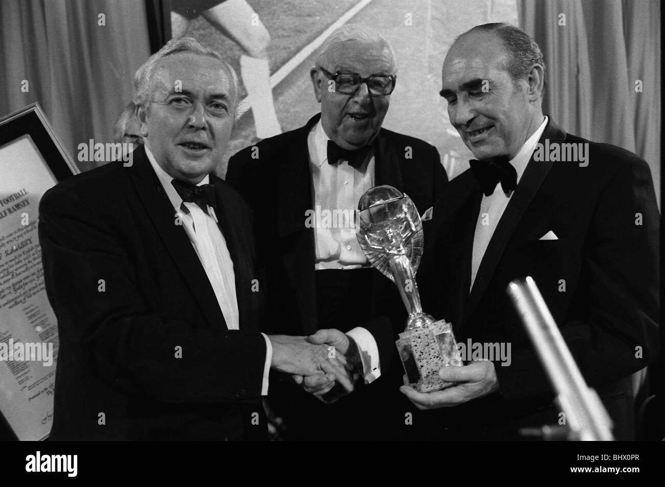 Sir Alf Ramsey holds World Cup at Cafe Royal July 1974 and shakes hands ...