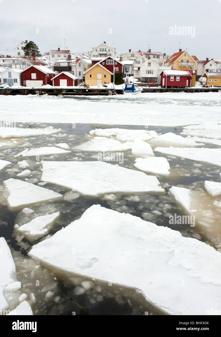 View of traditional village of Grundsund during winter with sea ice n ...
