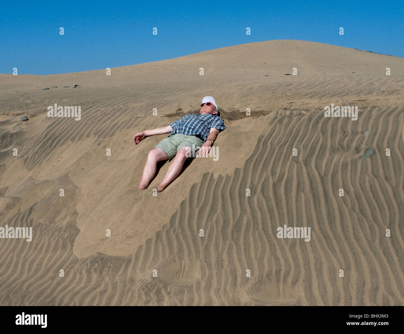 Man in the sand Stock Photo - Alamy