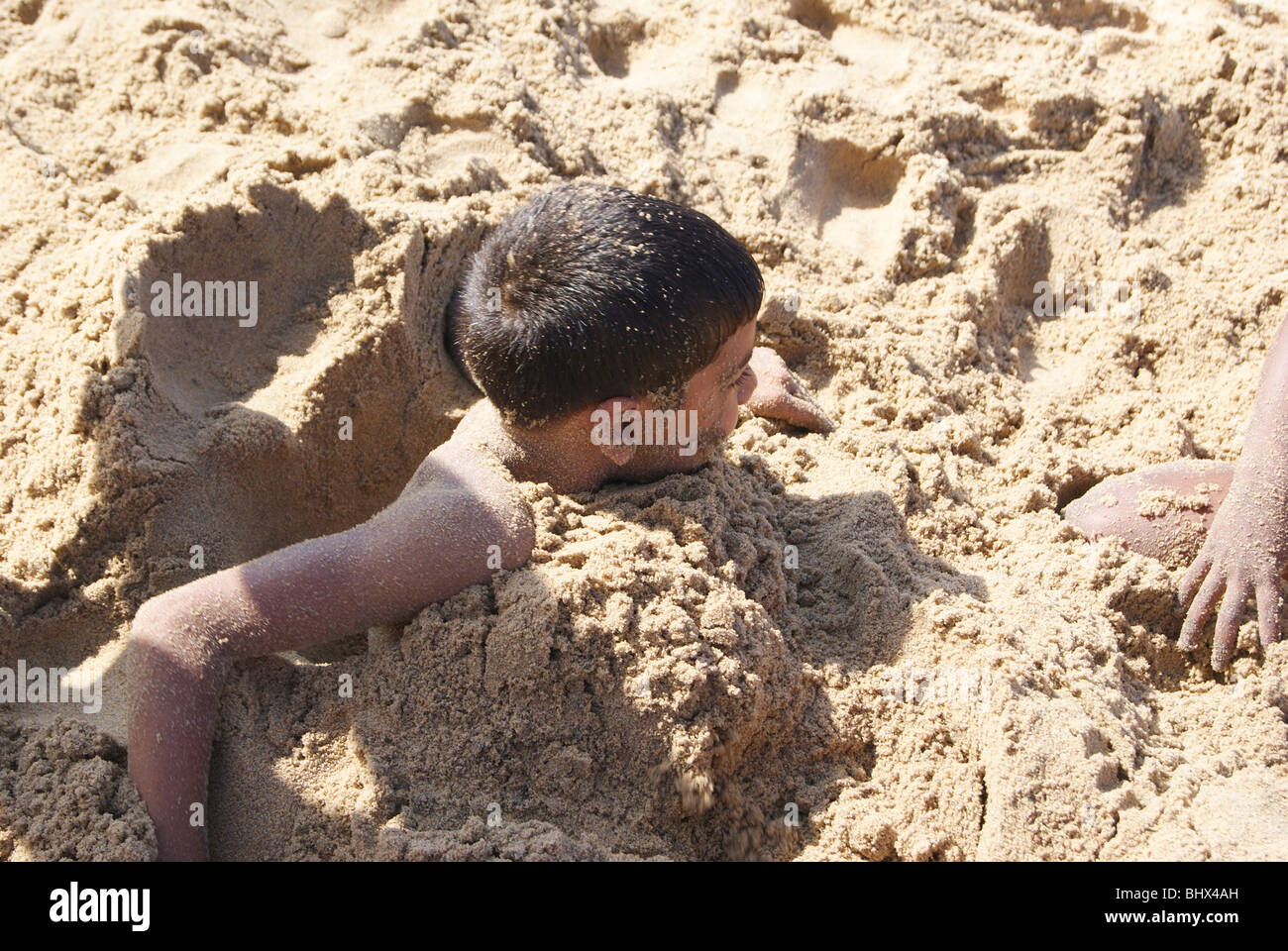 Small Boy Playing Inside sand Dunes.Funny Kid scene from Kovalam ...