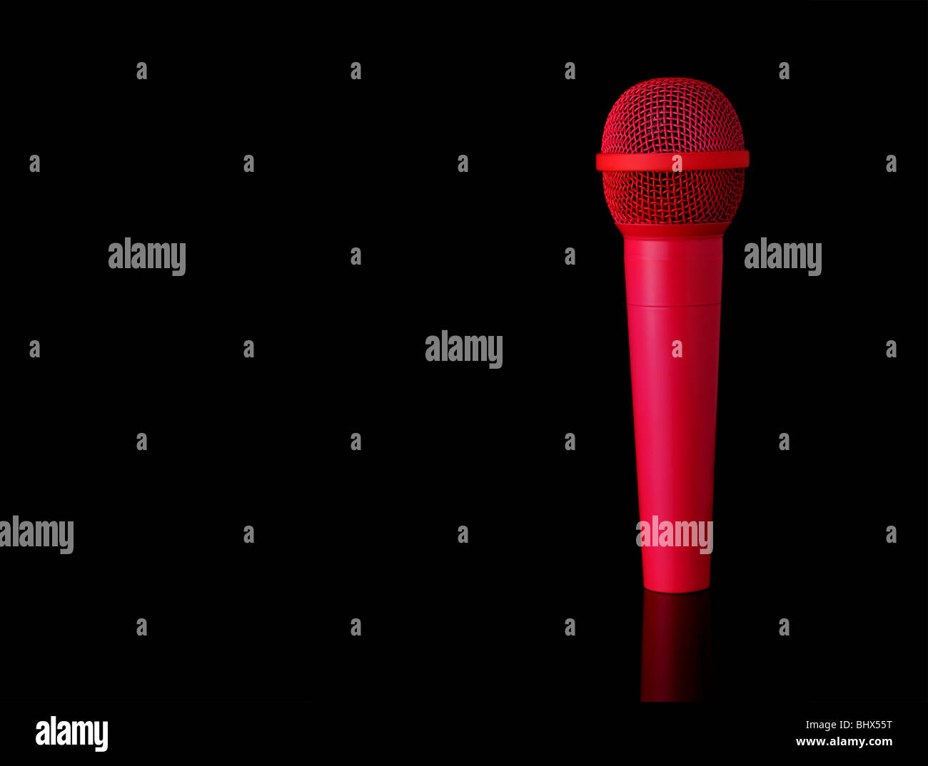 Bright pink microphone on black background Stock Photo - Alamy