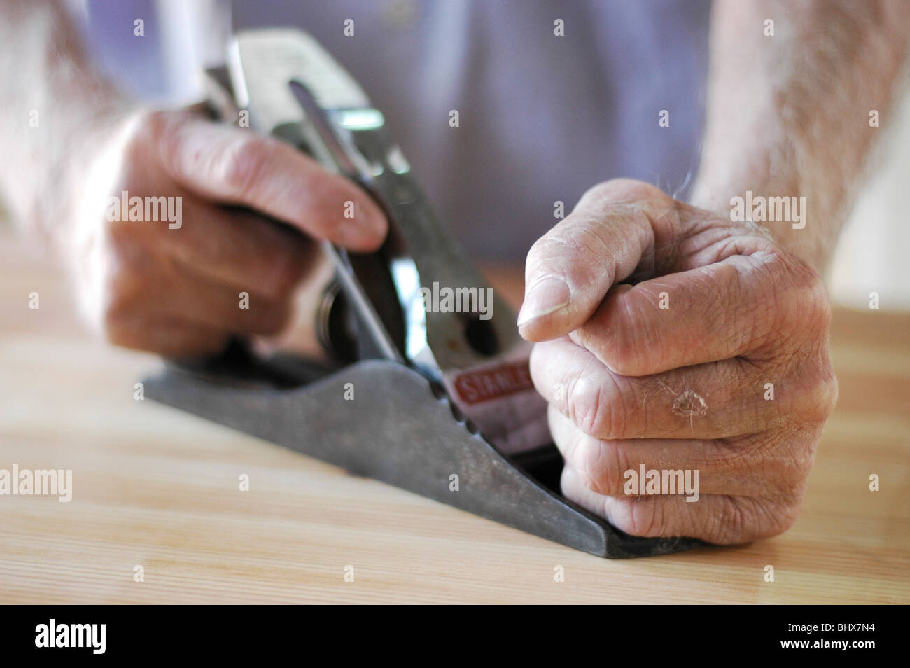 Hands of a carpenter using a carpenter's plain Stock Photo - Alamy