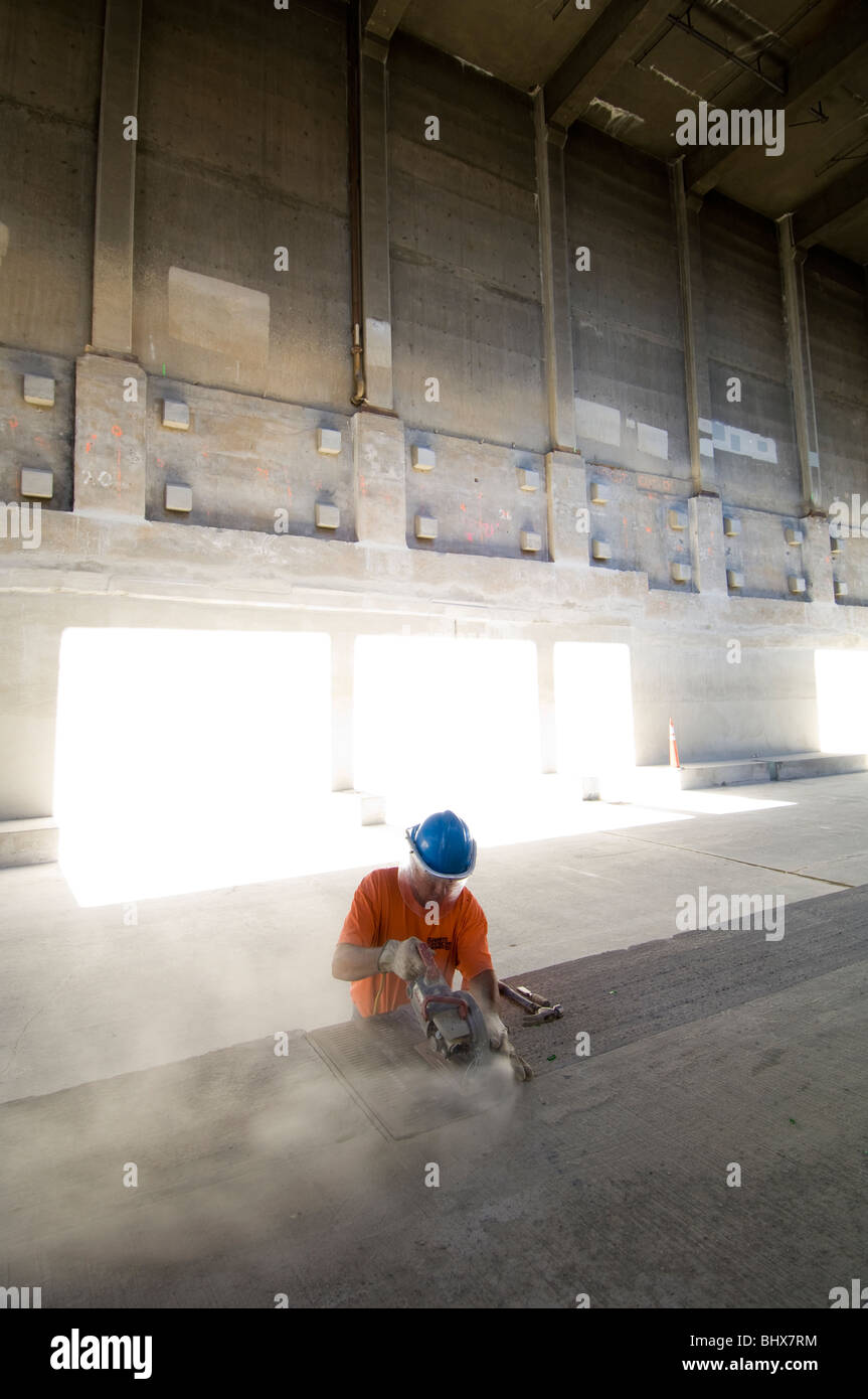 construction worker cutting concrete with a concrete saw Stock Photo ...