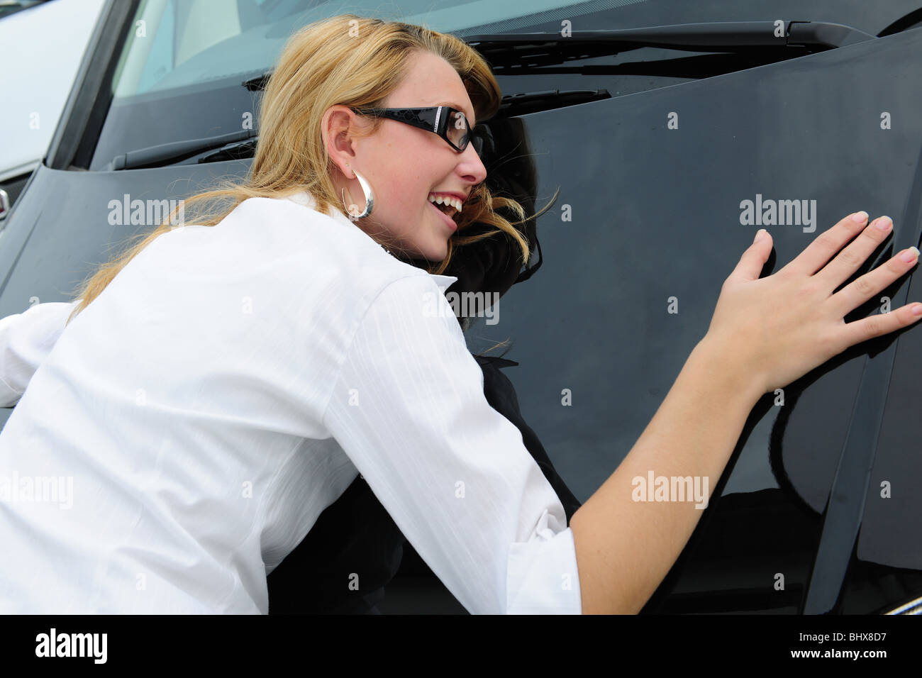 woman loves her new car and hugs it Stock Photo - Alamy