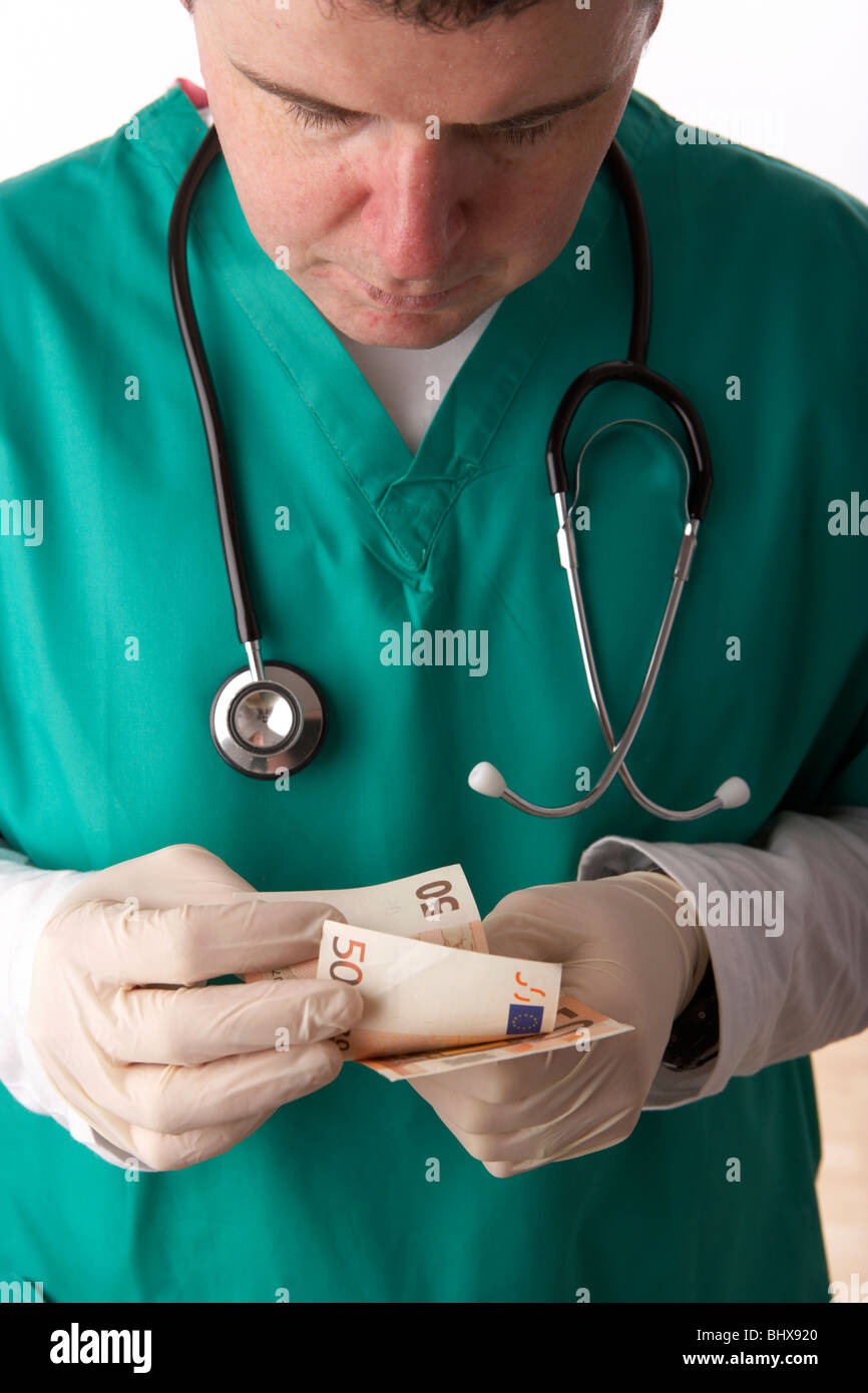 man wearing medical scrubs and stethoscope counting 50 euro banknotes ...
