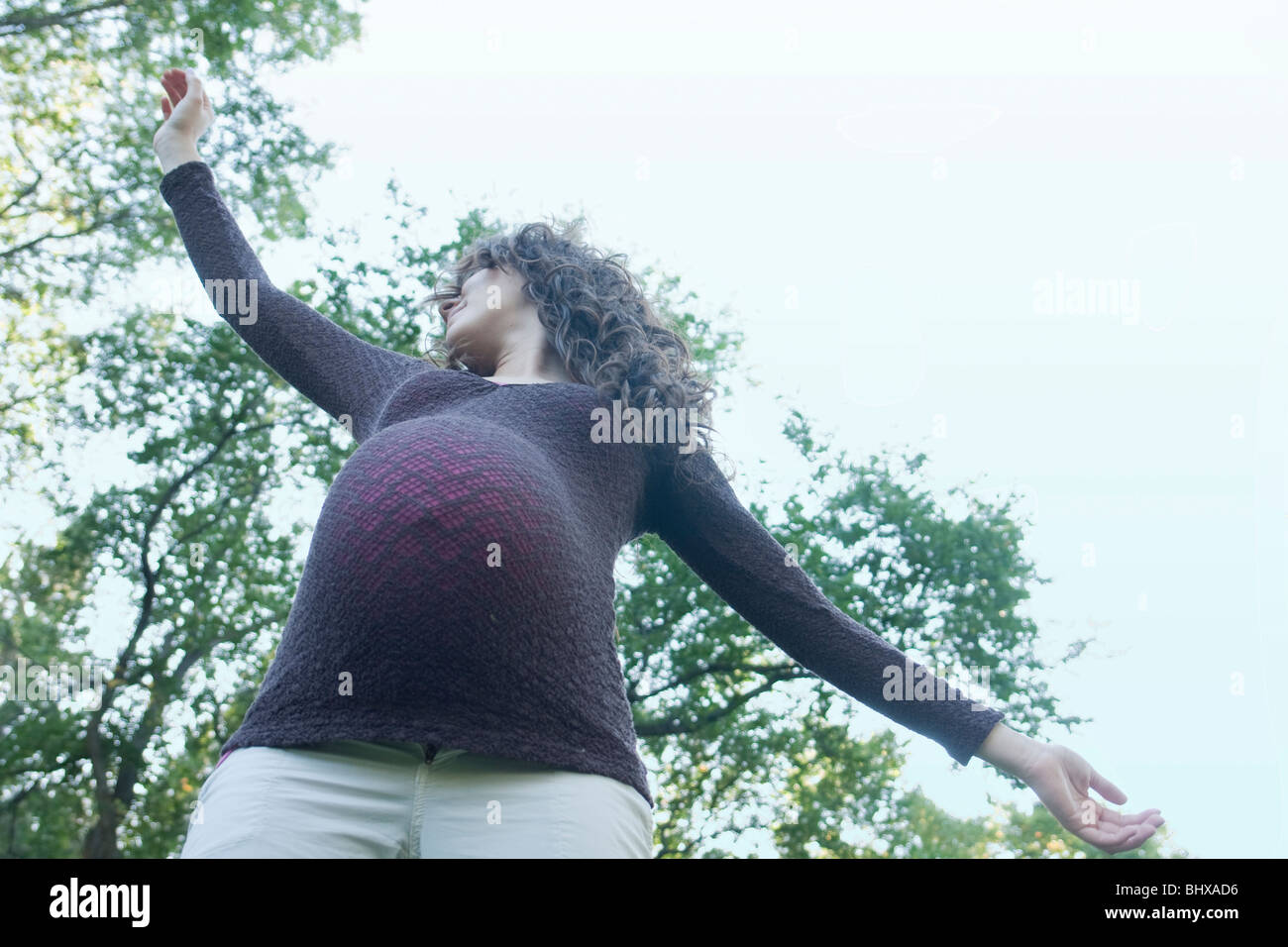 Low Angle Of Very Pregnant Woman With Arms Outstretched, Manitoba ...