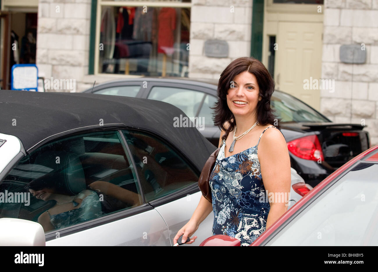 Woman Getting Into Her Convertible Car Stock Photo - Alamy