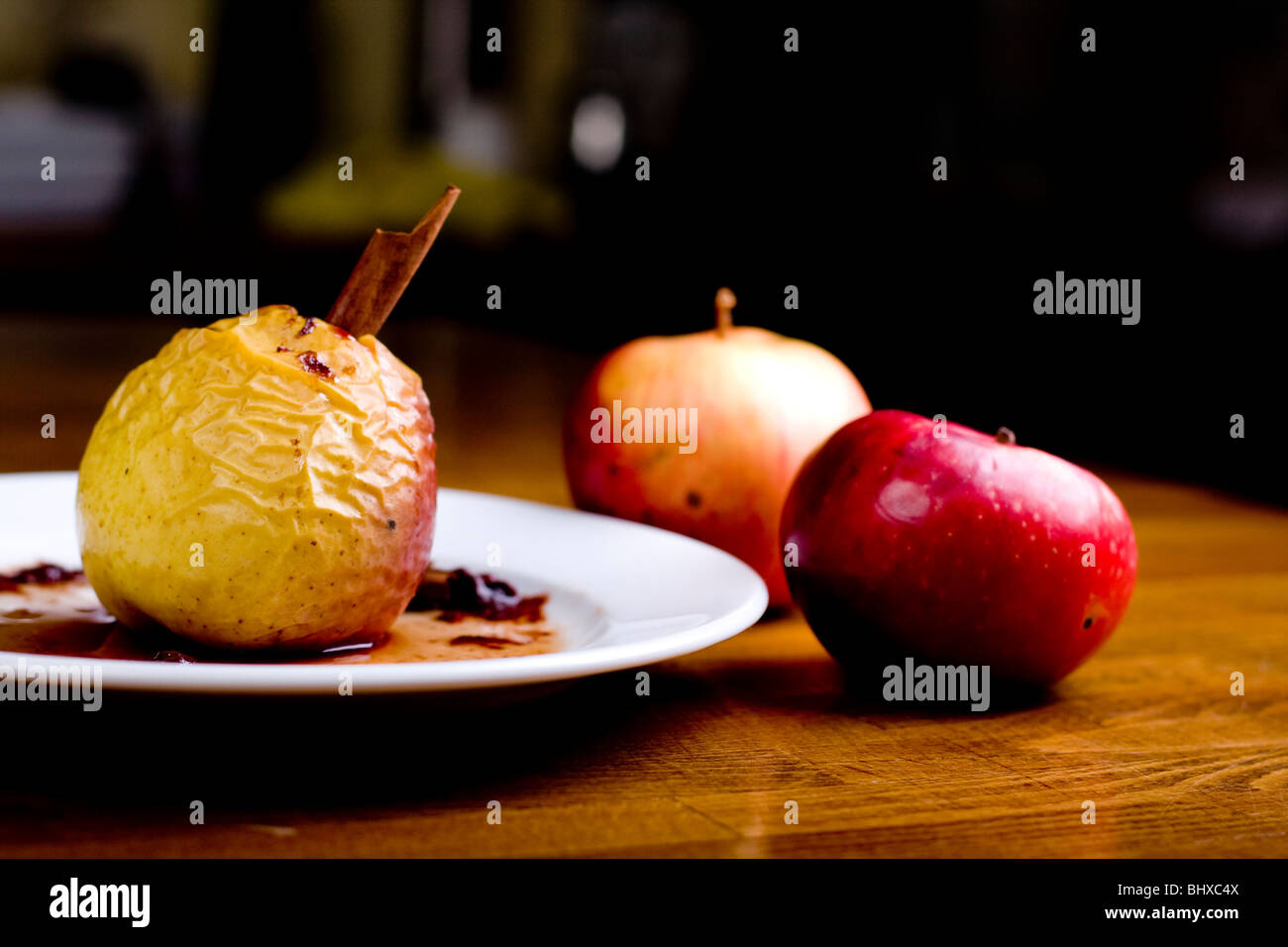 Hot baked apple with cinnamon sticks Stock Photo - Alamy
