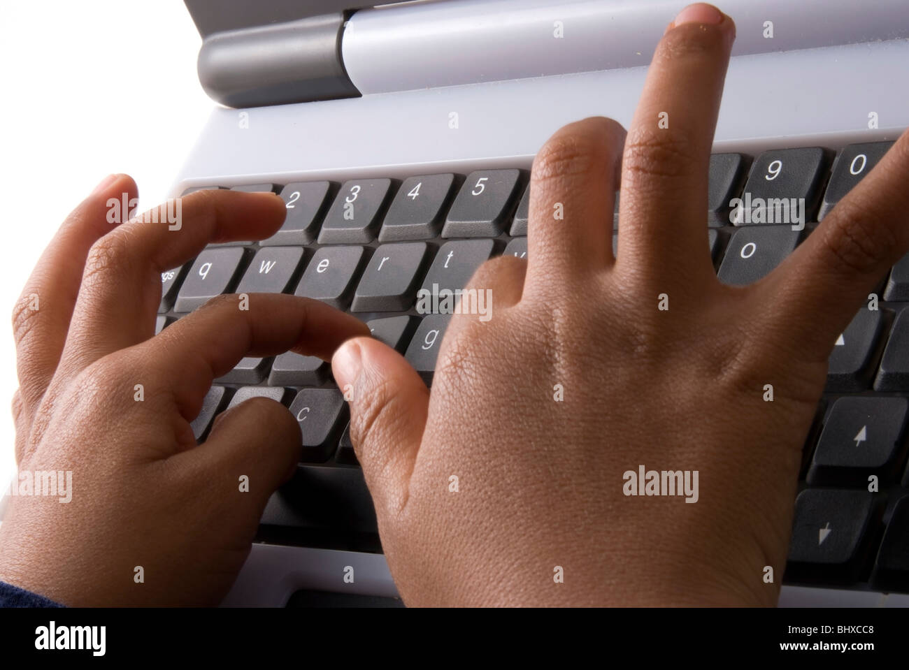Young boy typing on a laptop Stock Photo - Alamy