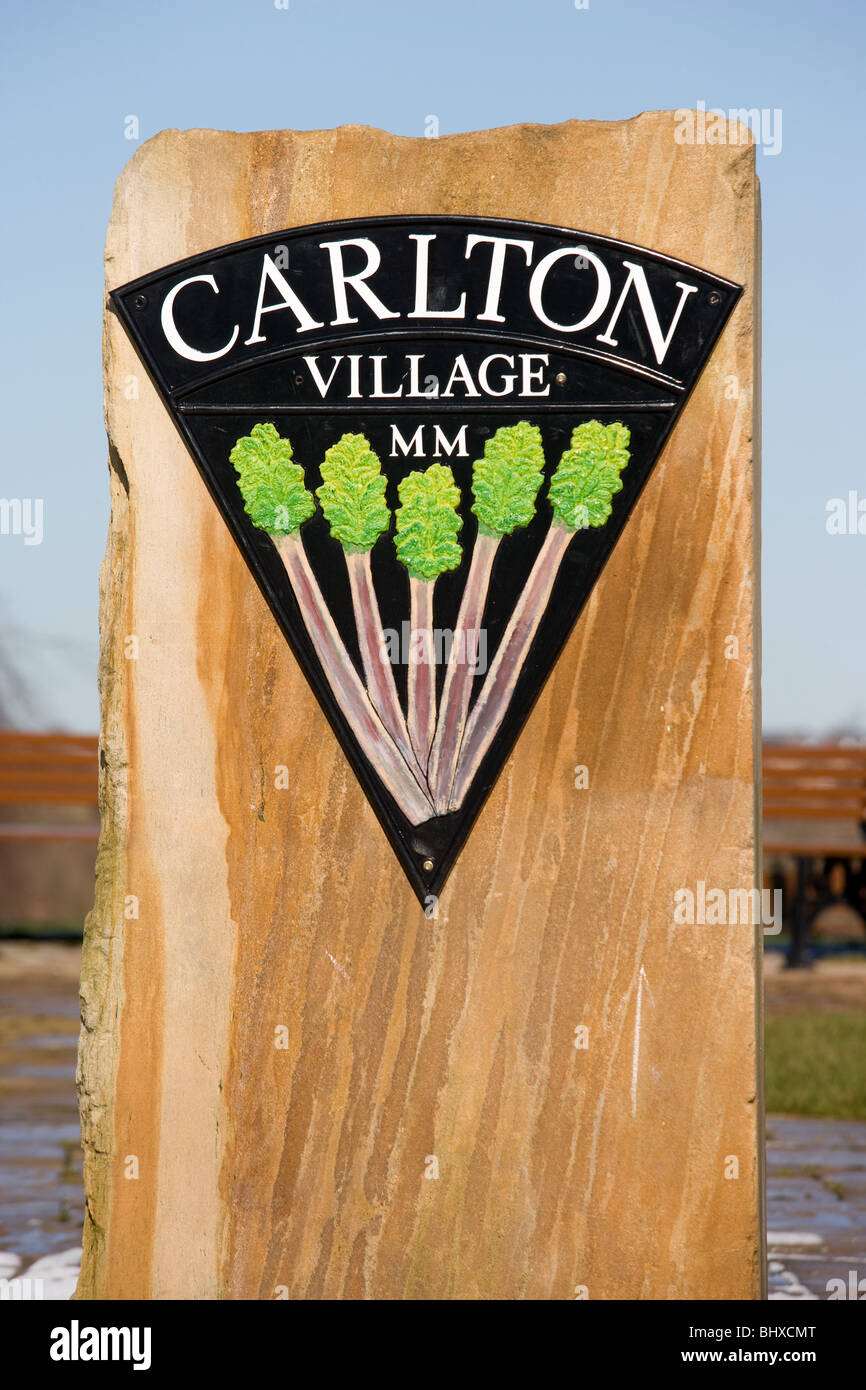 Carlton Village sign showing Rhubarb On The Sign Stock Photo - Alamy