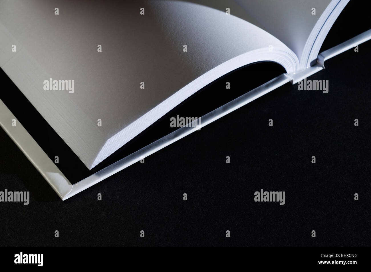 Closeup of an open blank book in black background Stock Photo - Alamy