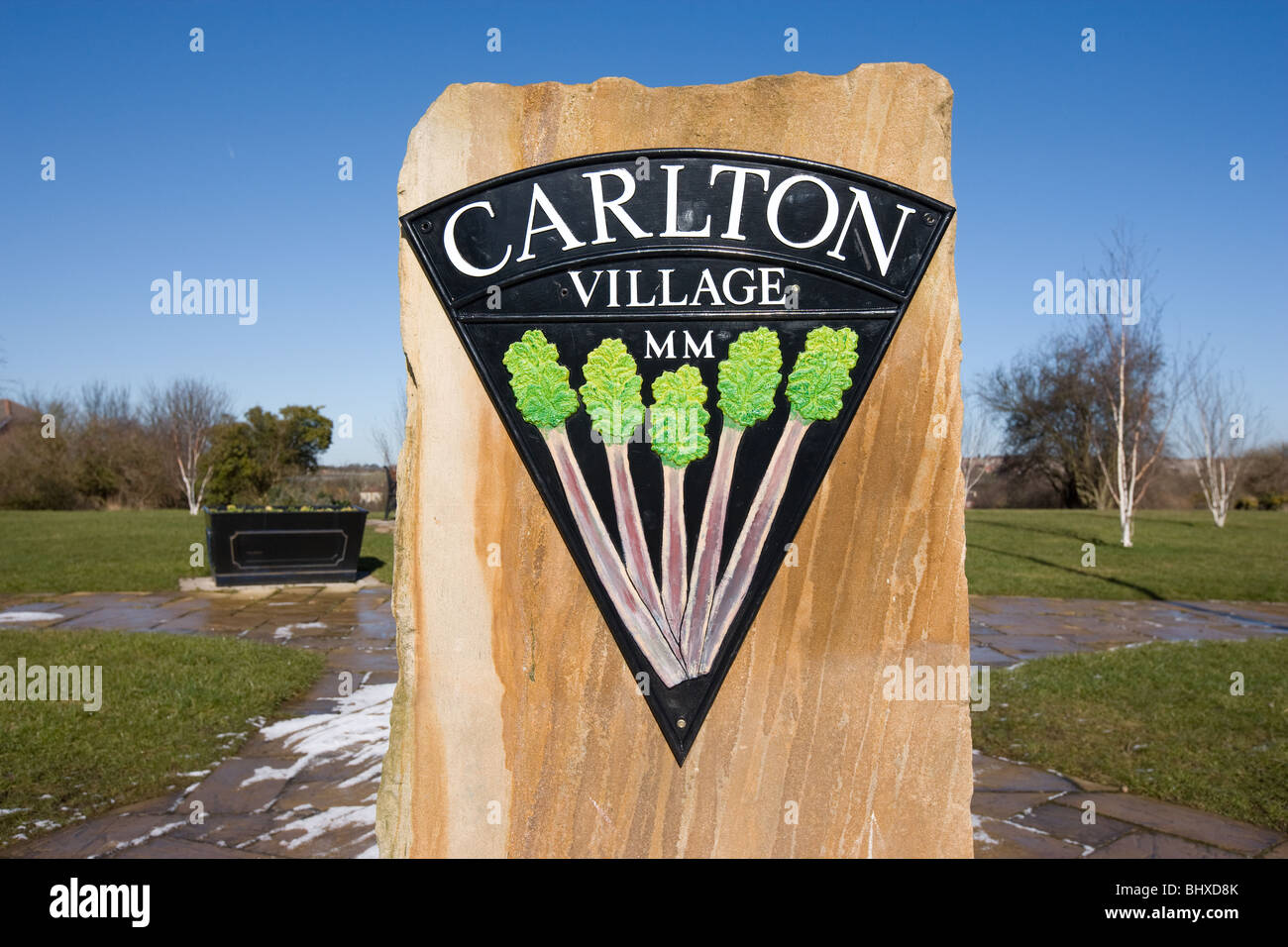 Carlton Village sign showing Rhubarb On The Sign Stock Photo - Alamy
