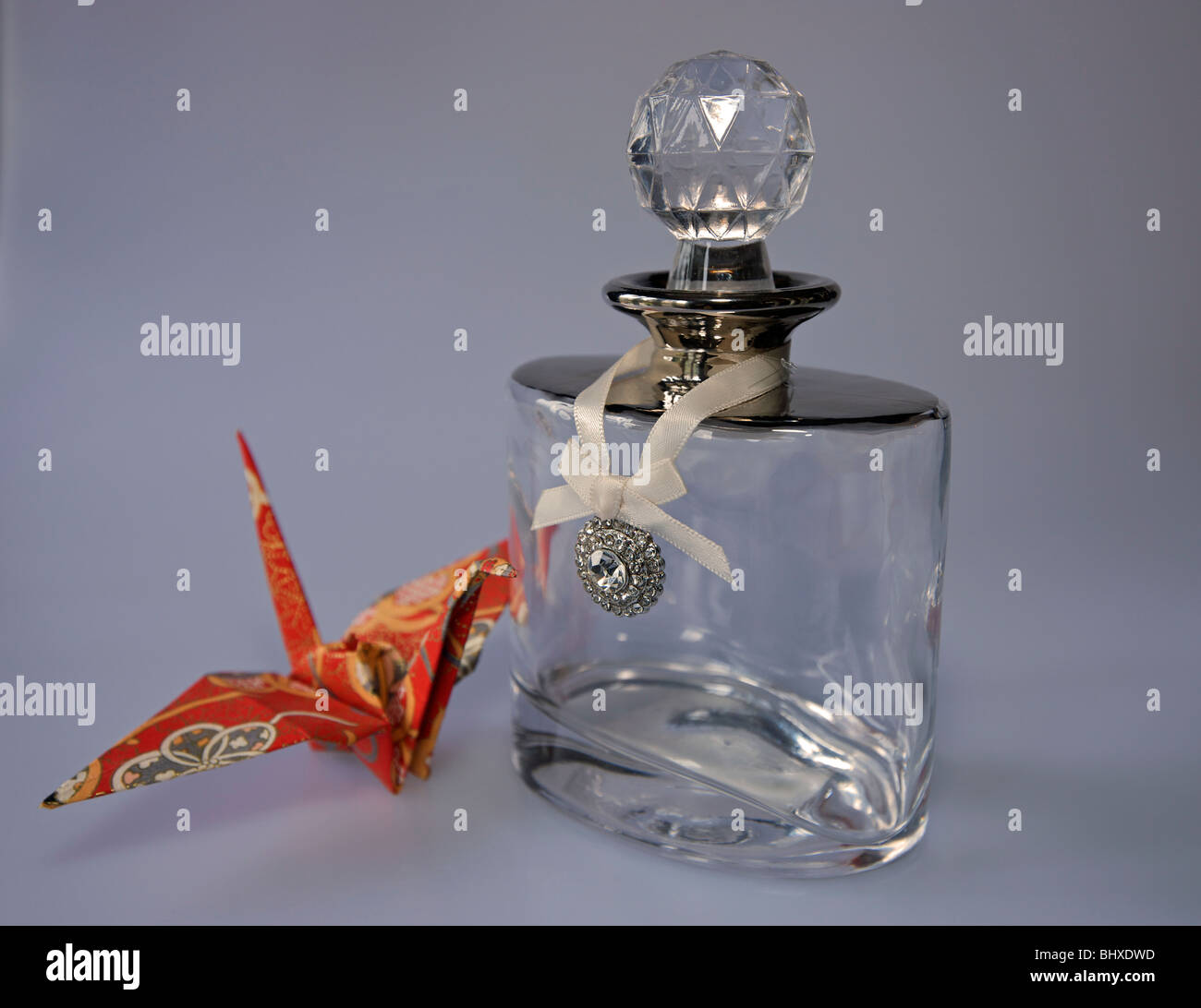 crystal glass container and origami crane Stock Photo - Alamy