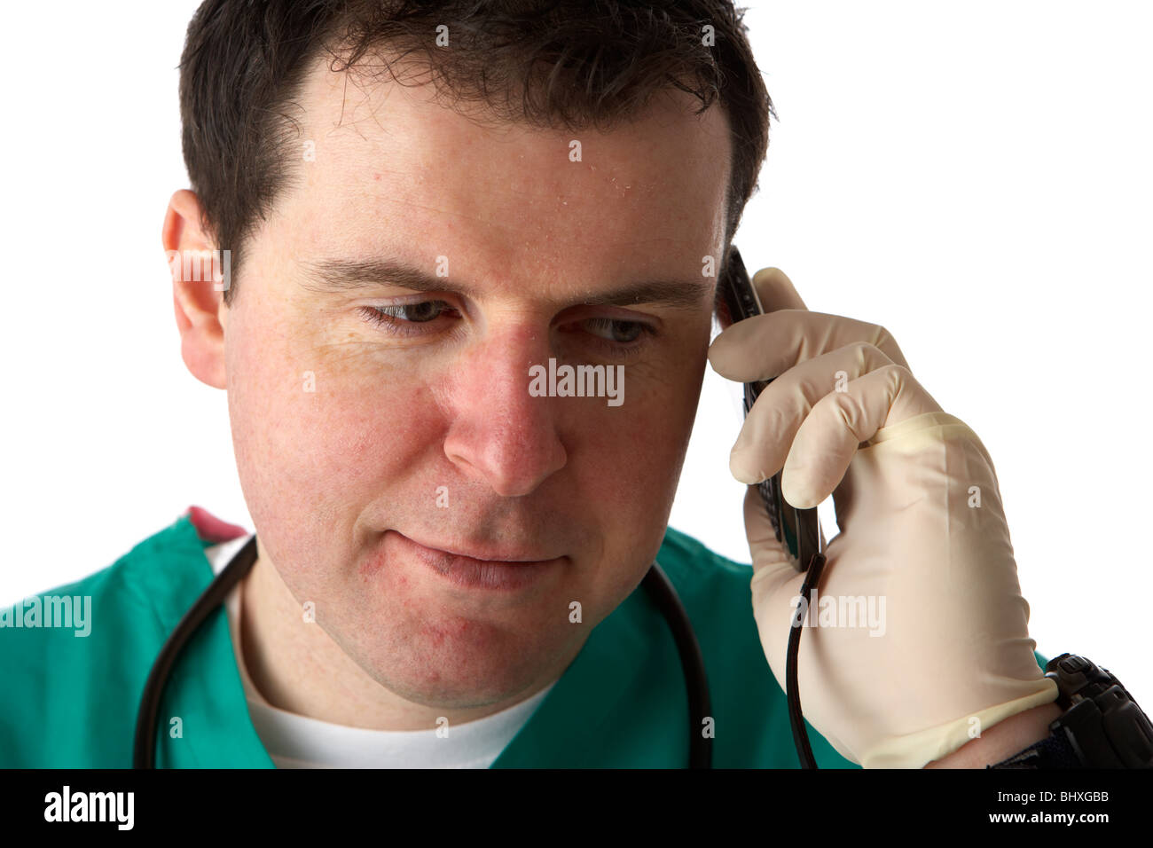 man wearing medical scrubs and stethoscope holding mobile phone to his ...