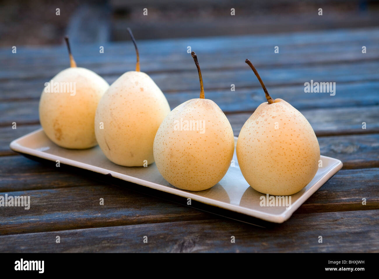 Basket of asian pears on wood table Stock Photo - Alamy
