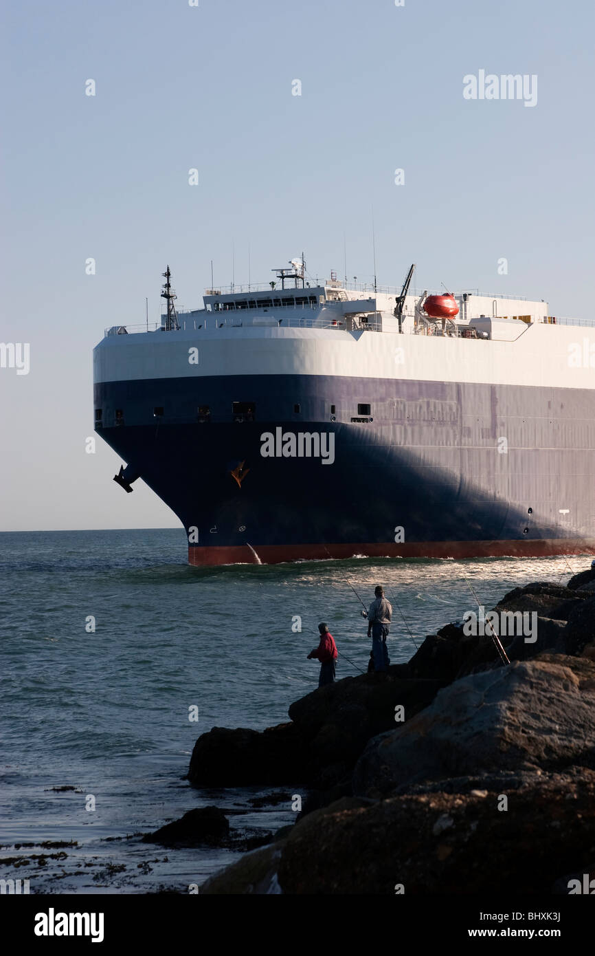 Cargo ship coming into port Stock Photo - Alamy