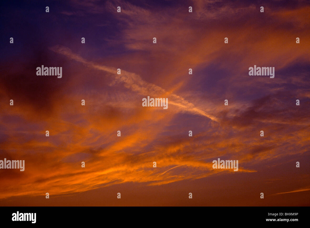 Jet Trails At Sunset Evening Sky Stock Photo - Alamy