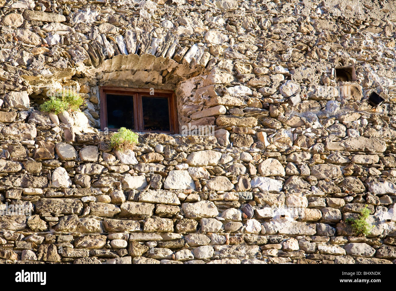Window in a wall of natural stone Stock Photo - Alamy
