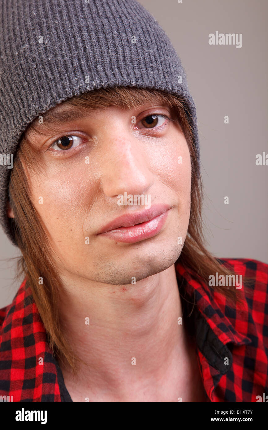 young man with red-black checked shirt and cap Stock Photo - Alamy