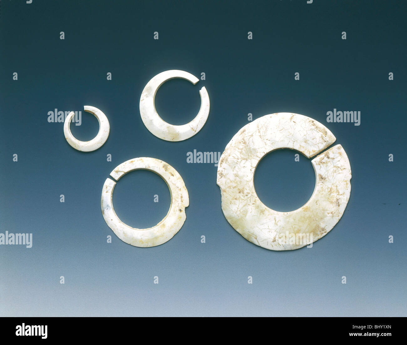 Four altered jade asymmetrical slit-discs, Neolithic, Liangzhu culture ...