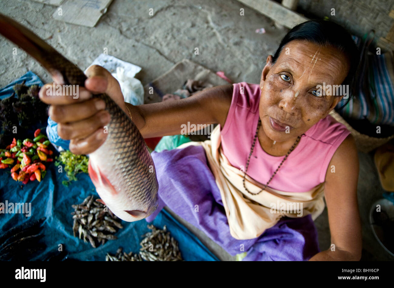 Manipuri/Indian Fisher woman offering fish Stock Photo - Alamy