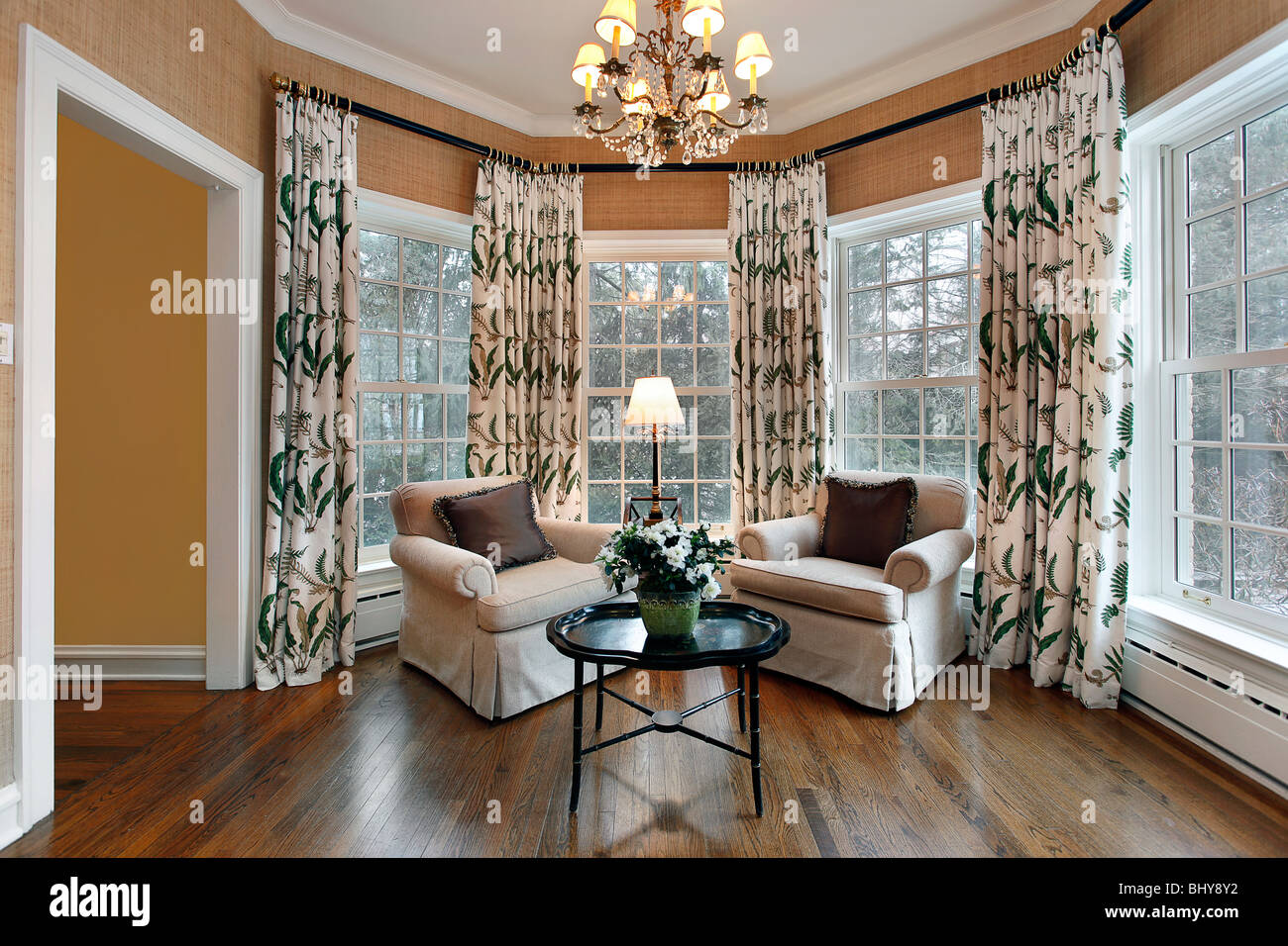 Den in upscale home with wall of windows Stock Photo - Alamy