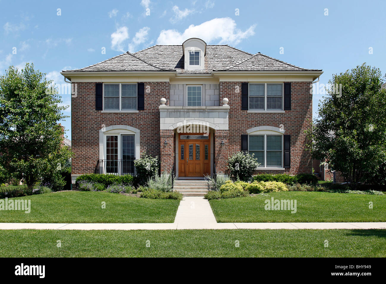 Brick home in suburbs with front door archway Stock Photo - Alamy