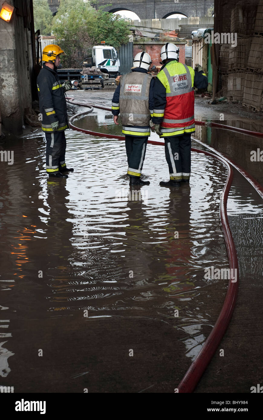 Firemen pumping rain water from under flooded bridge Stock Photo - Alamy