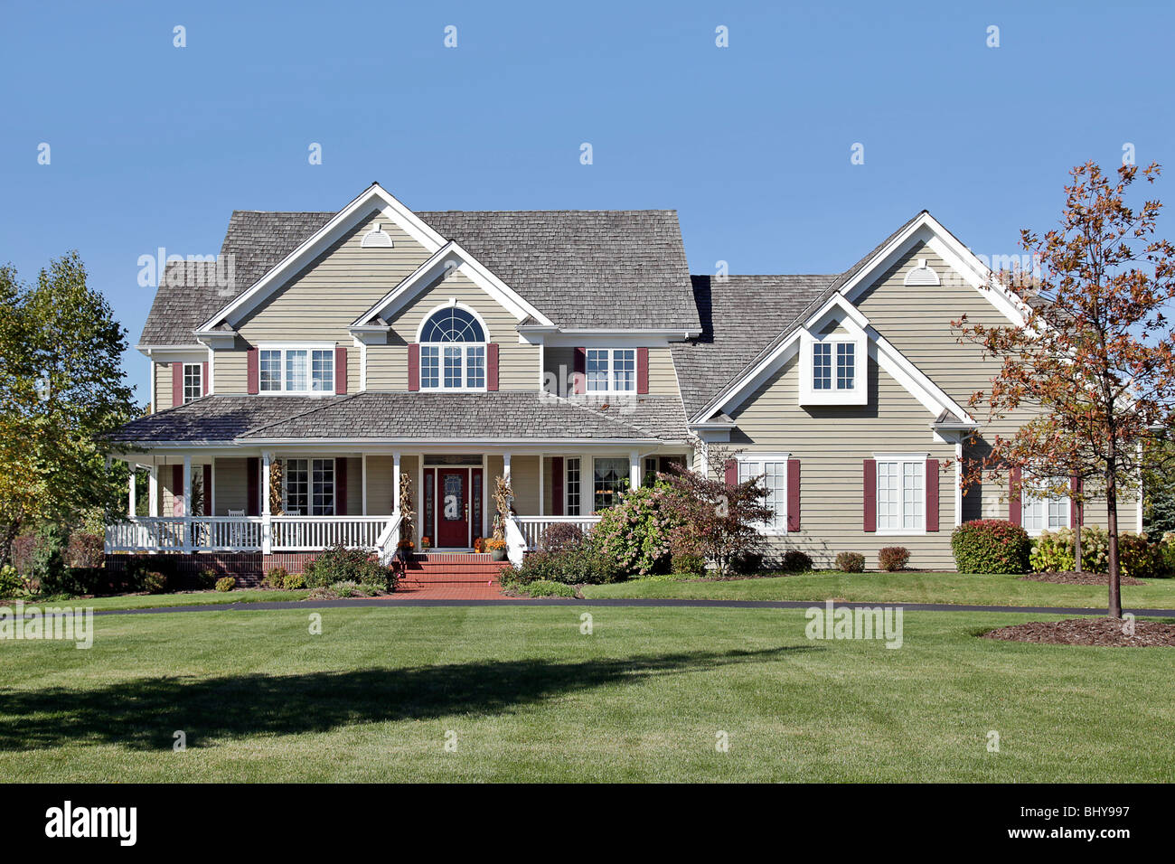 Large suburban home with front porch and cedar roof Stock Photo - Alamy