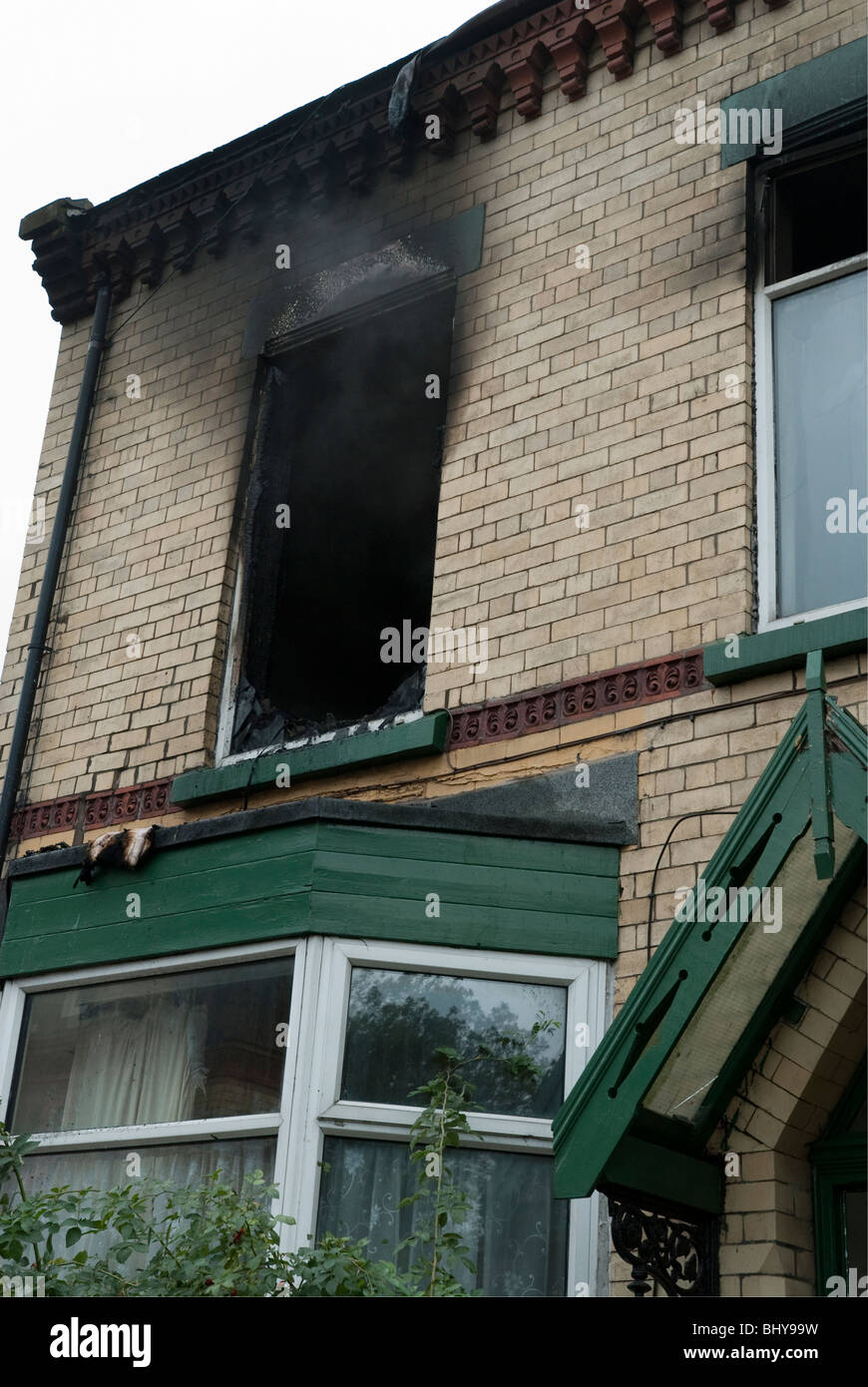 Smoke coming from bedroom window of house on fire Stock Photo - Alamy