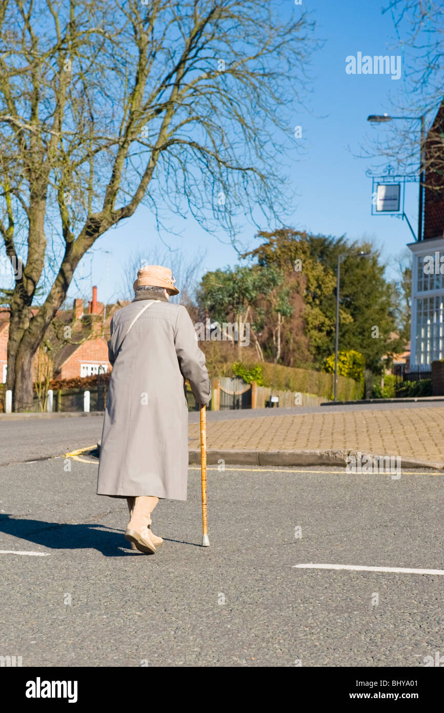 Old woman walking stick crossing hi-res stock photography and images ...