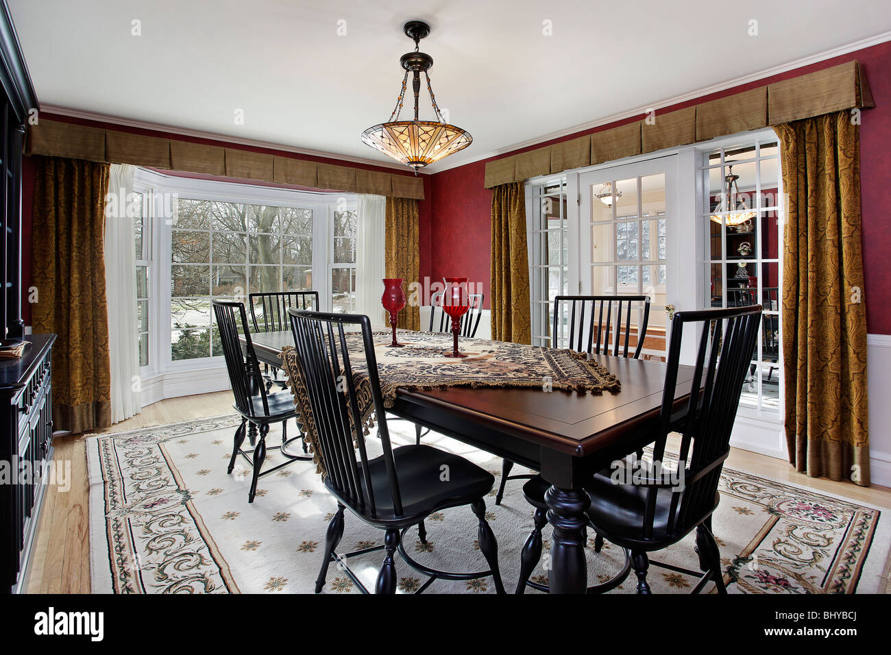 Dining room in luxury home with picture window Stock Photo - Alamy