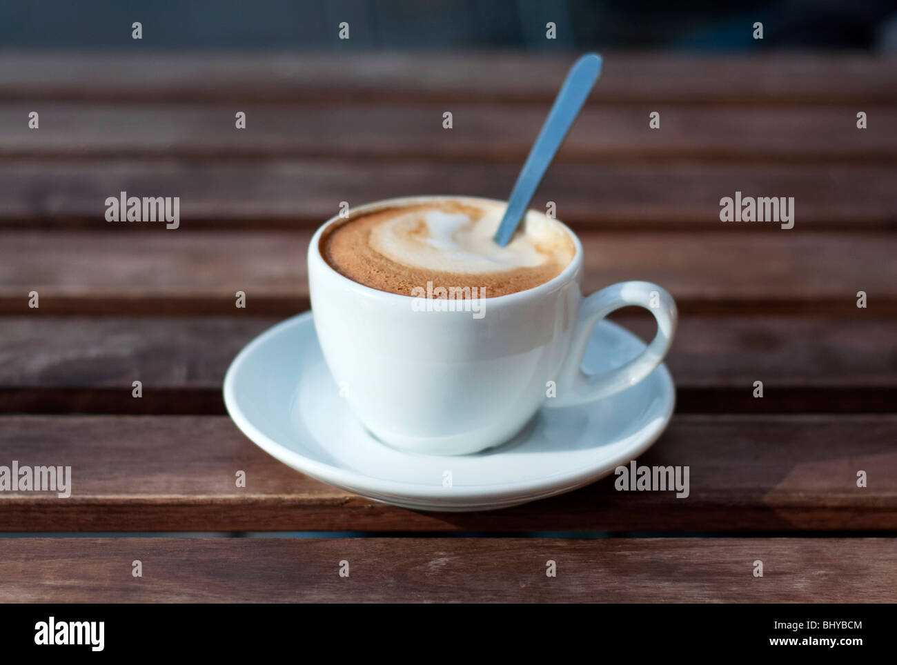 Coffee, latte in a white coffee cup with saucer and spoon, shallow ...