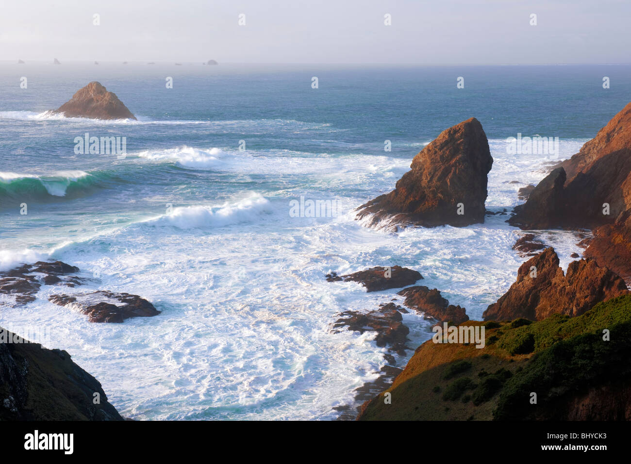 Evening light on offshore sea stacks along the southern Oregon Coast at ...