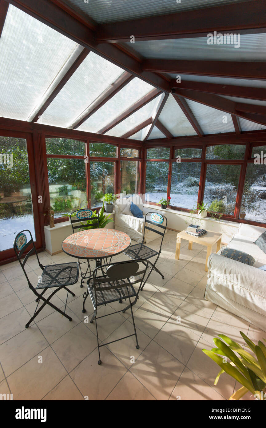 conservatory tables chairs plants room in house next to garden Stock ...