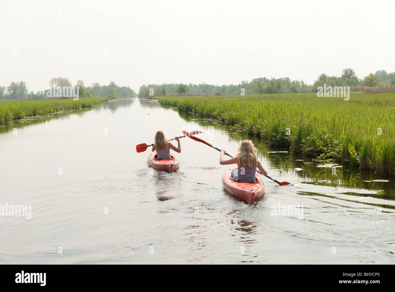 Young girls Kayaking in wilderness and having a lot of fun on a ...