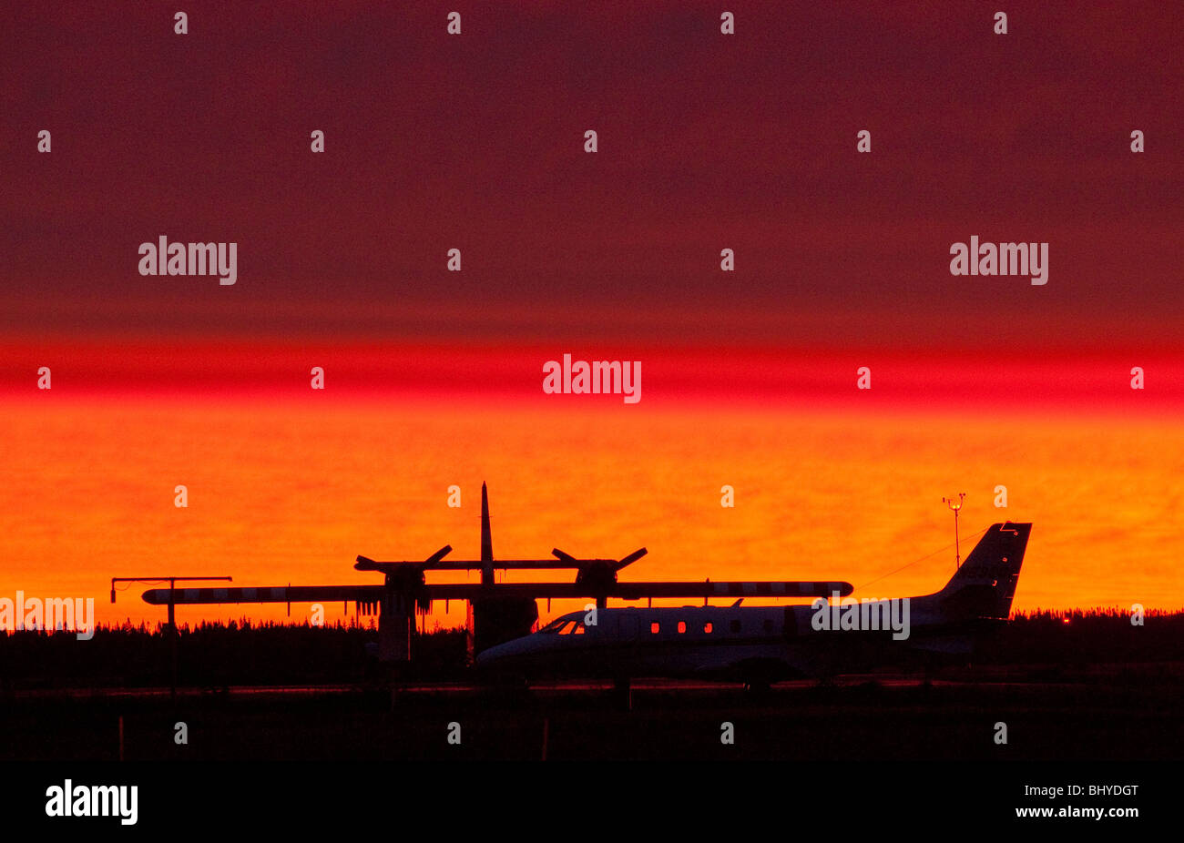 NEWFOUNDLAND, DEER LAKE AIRPORT, COMMERCIAL AIRPLANES SILHOUETTED BY ...