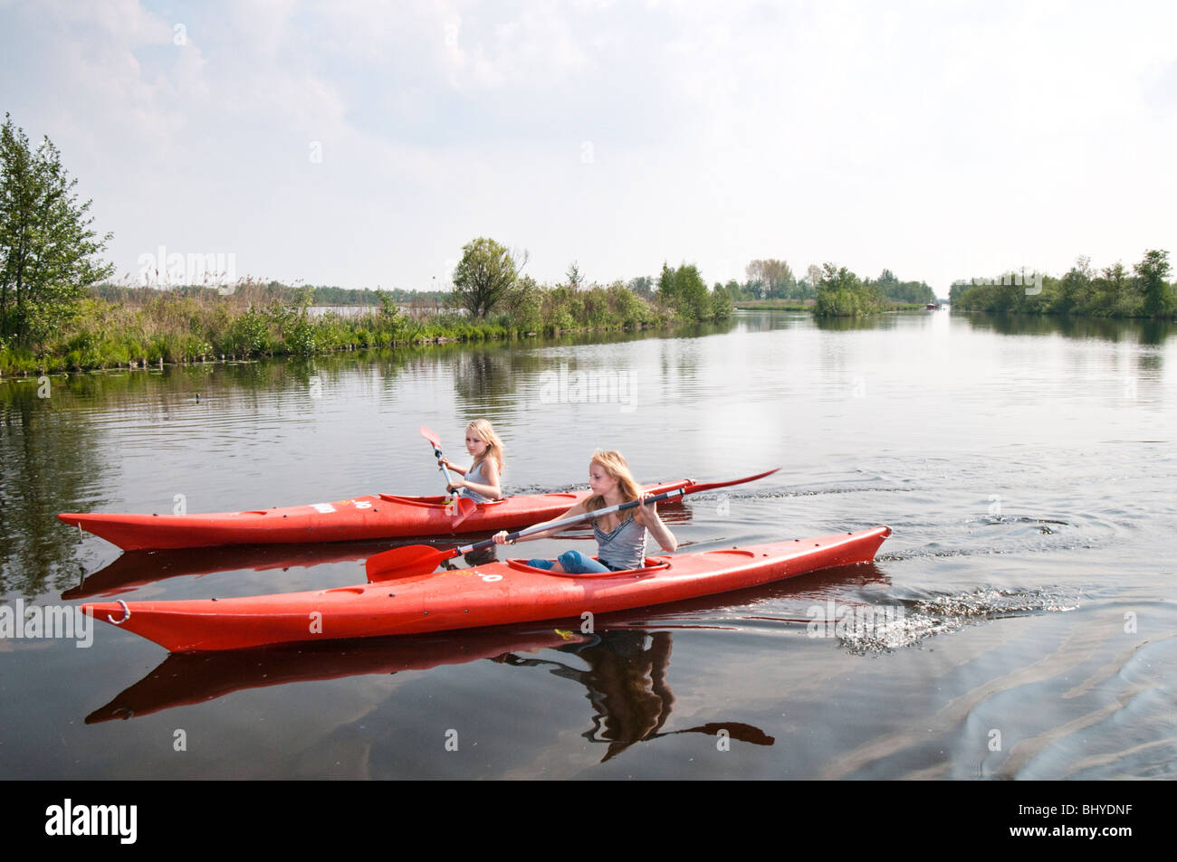 Young girls Kayaking in wilderness and having a lot of fun on a ...