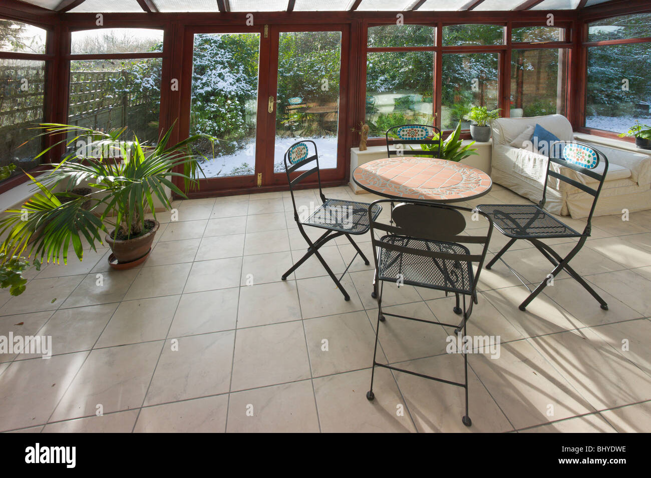 conservatory tables chairs plants room in house next to garden Stock ...